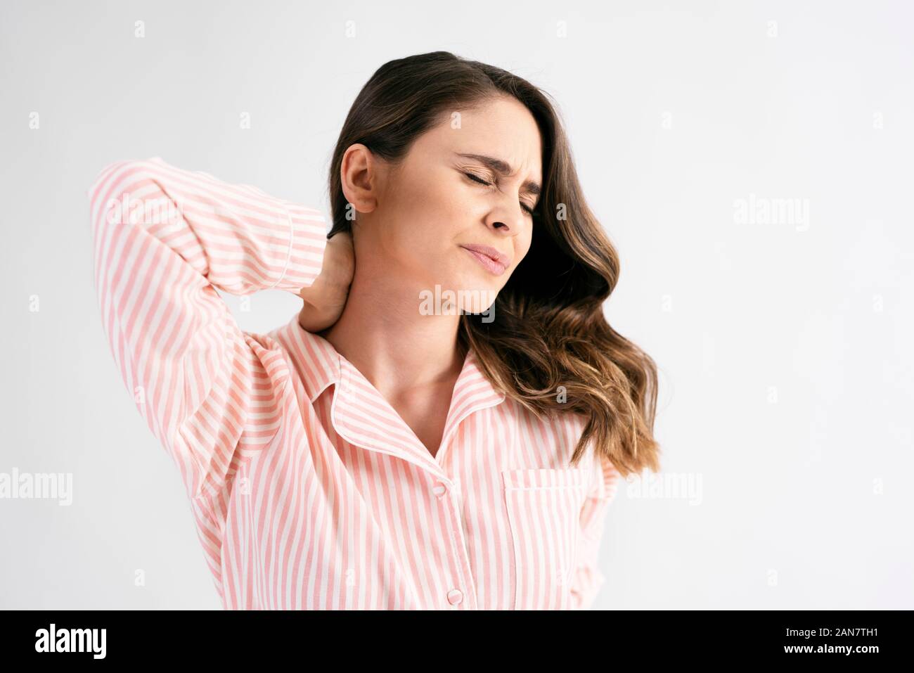 Young woman suffering from neck pain Stock Photo - Alamy