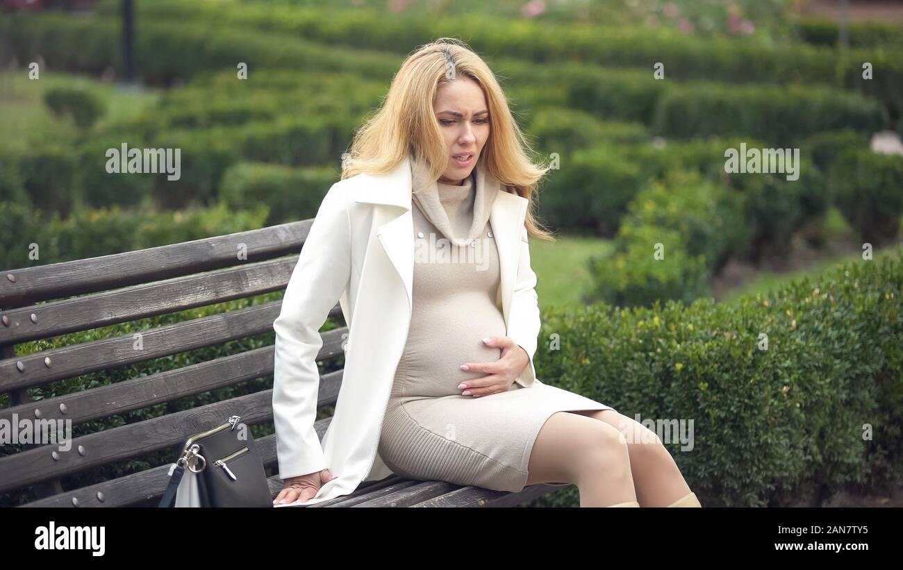 Disturbed pregnant woman feeling sharp abdominal pain, risk of preterm ...