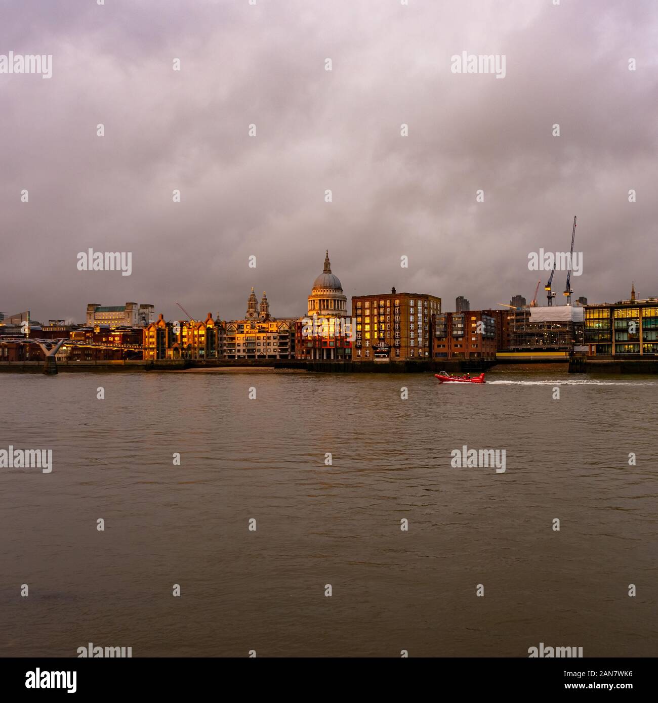 Golden sunlight illuminating St Paul's Cathedral after heavy rain ...