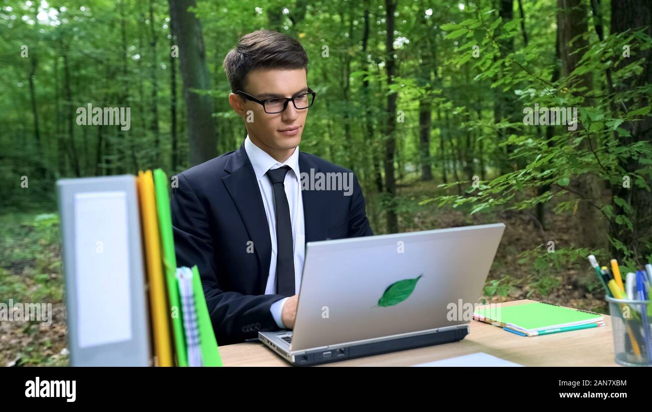 Concentrated business person working on laptop, energy efficiency ...