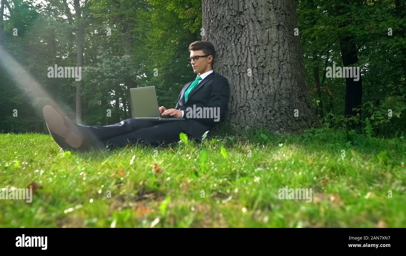 Businessman laptop working under tree hi-res stock photography and ...