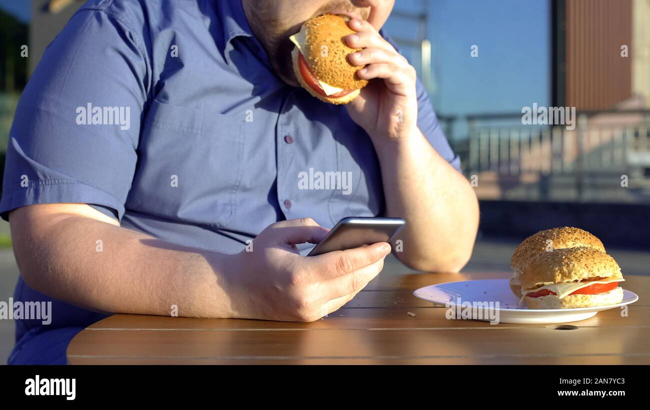 Fat man eating burger restaurant hi-res stock photography and images ...