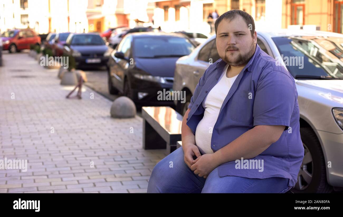 Fat man sitting on bench hi-res stock photography and images - Alamy