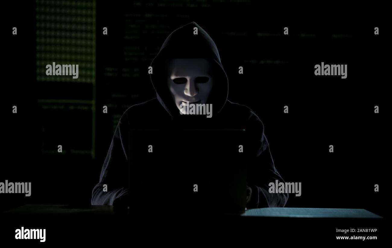 Hacker in hoodie cracking codes on laptop, cyberterrorism, internet ...