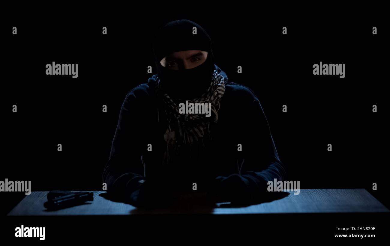 Dangerous terrorist in balaclava looking into camera, terrorism as ...