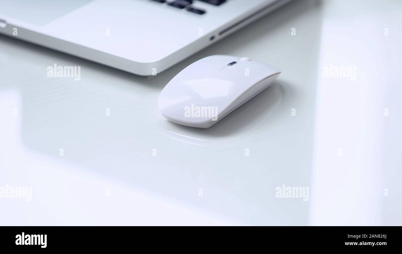 White wireless mouse near laptop table, office technology, computer ...