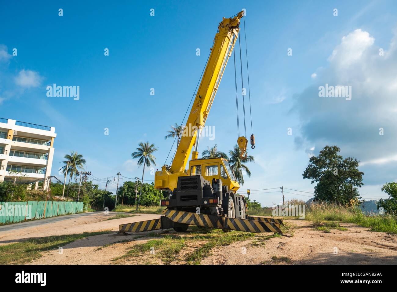 Yellow automobile crane with risen telescopic boom outdoors. Mobile ...