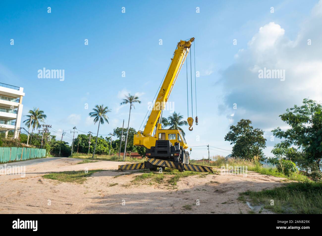 Yellow automobile crane with risen telescopic boom outdoors. Mobile ...