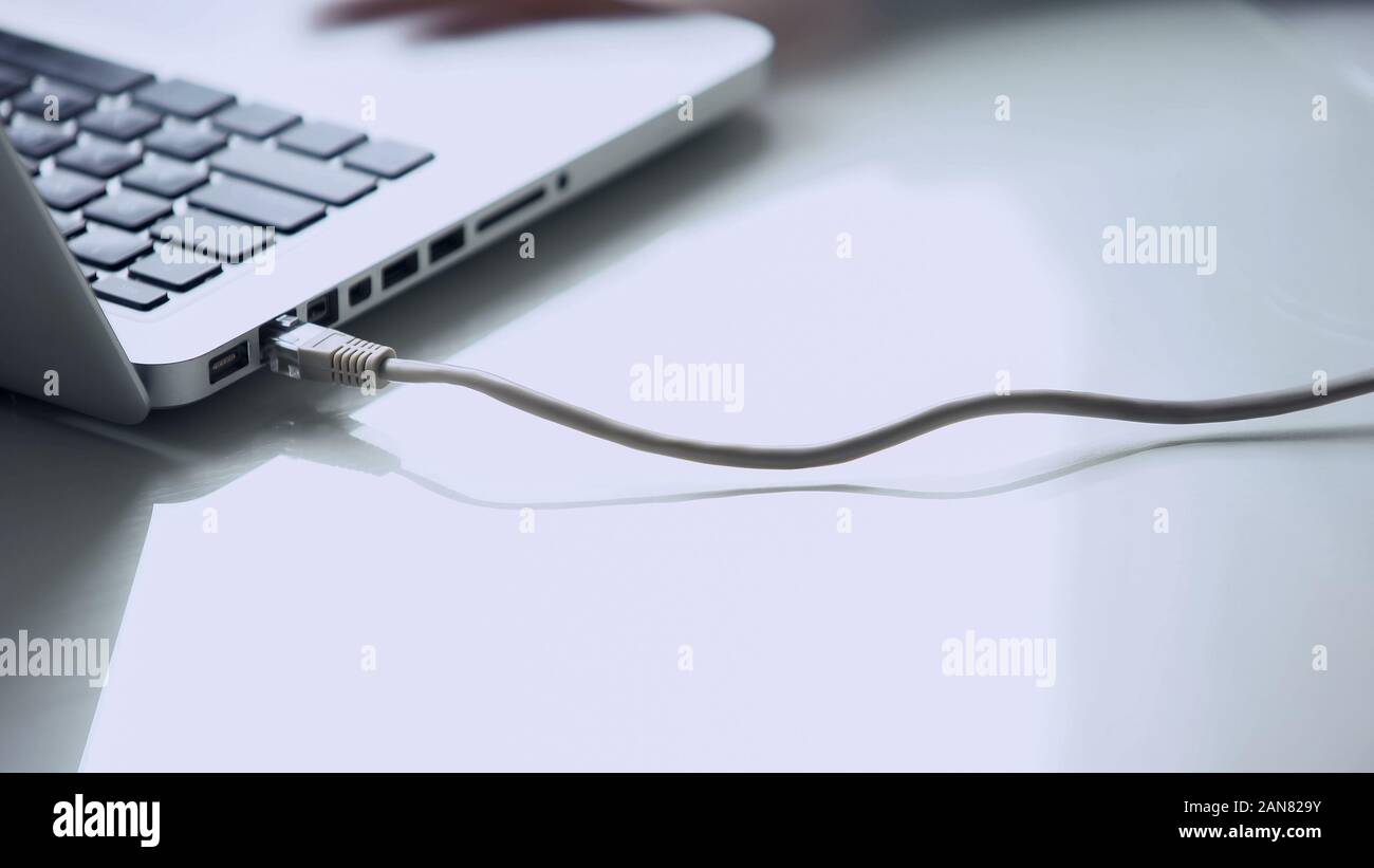 High speed internet cable connected to laptop, personal computer ...