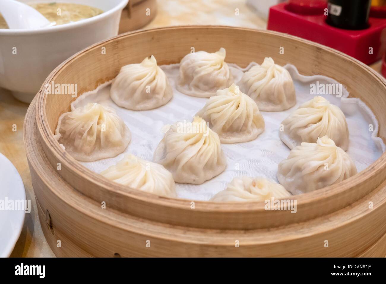 Xiao long bao soup dumpling buns with chopsticks in restaurant ...