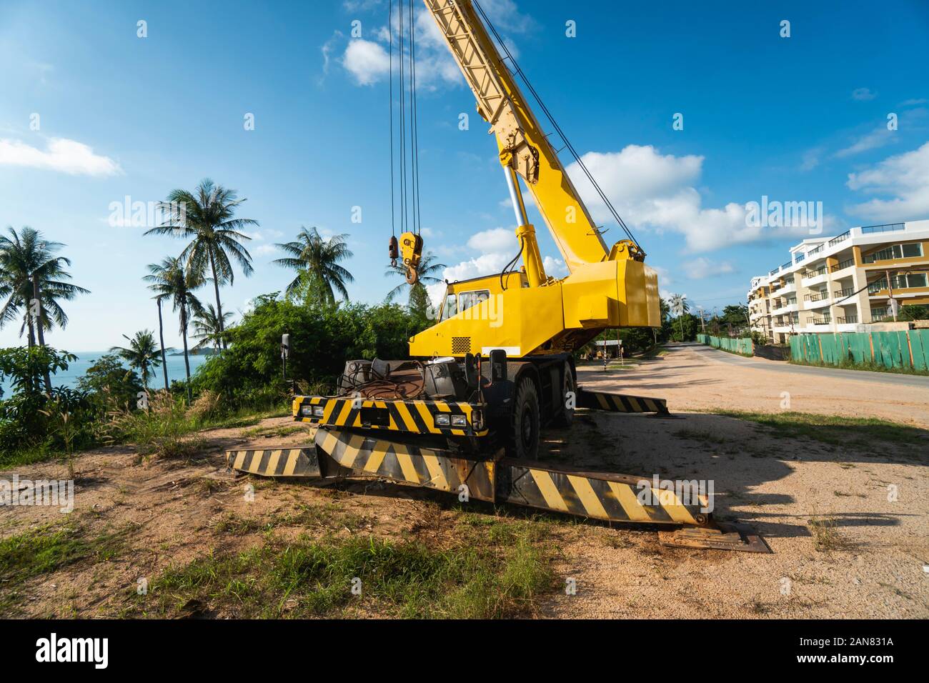 Yellow automobile crane with risen telescopic boom outdoors. Mobile ...