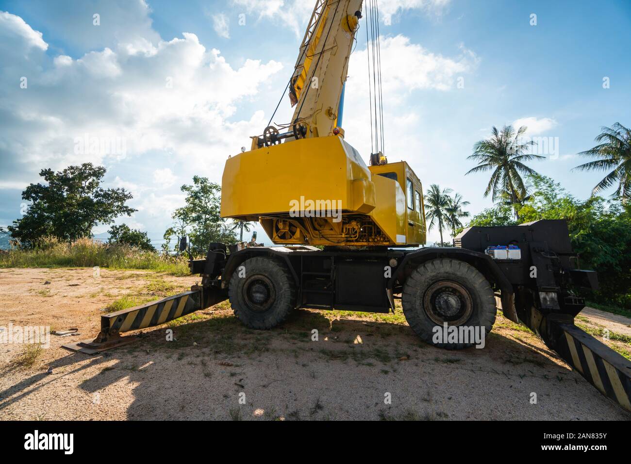 Yellow automobile crane with risen telescopic boom outdoors. Mobile ...