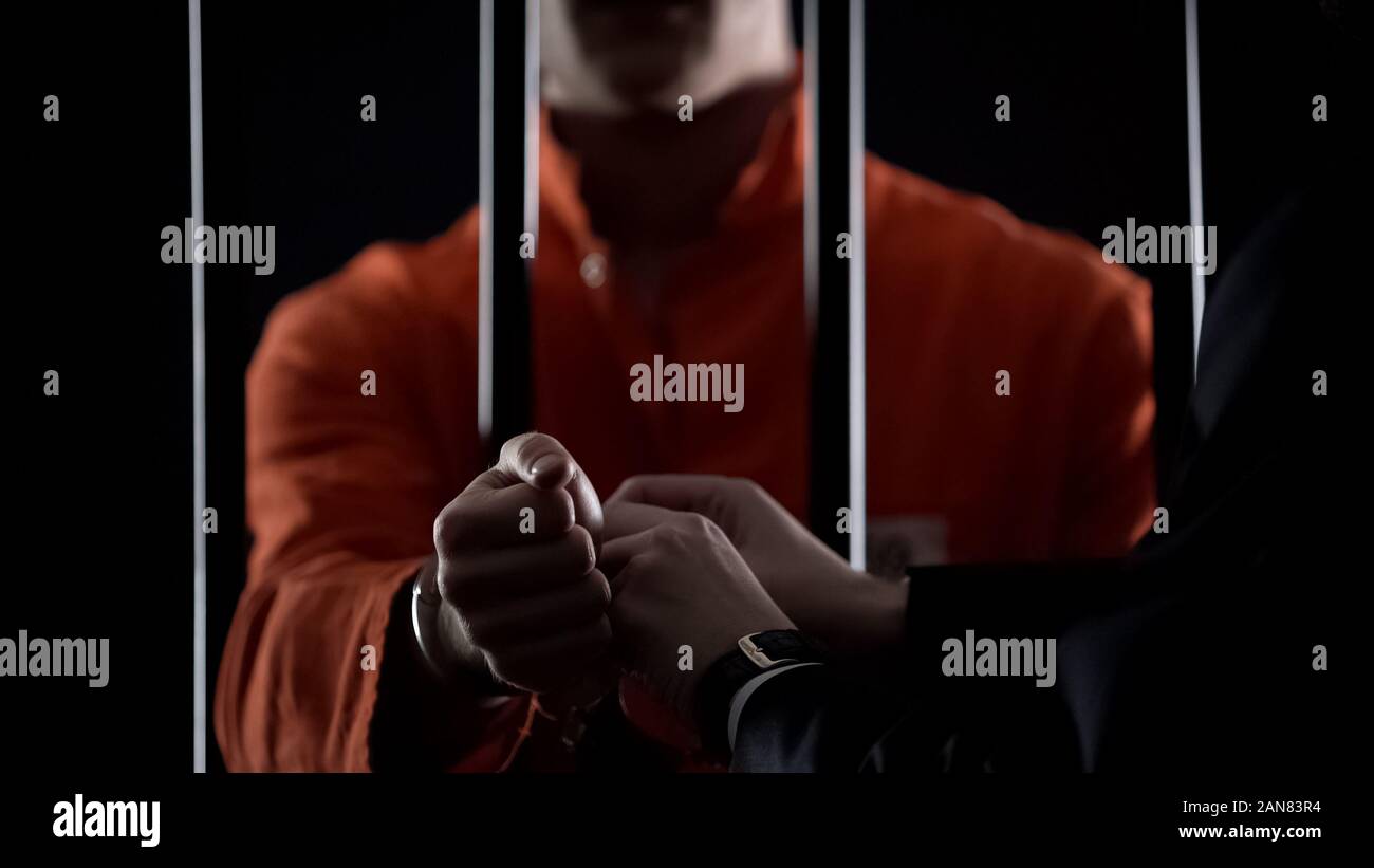 Guard taking handcuffs off criminal, releasing from jail due to good ...