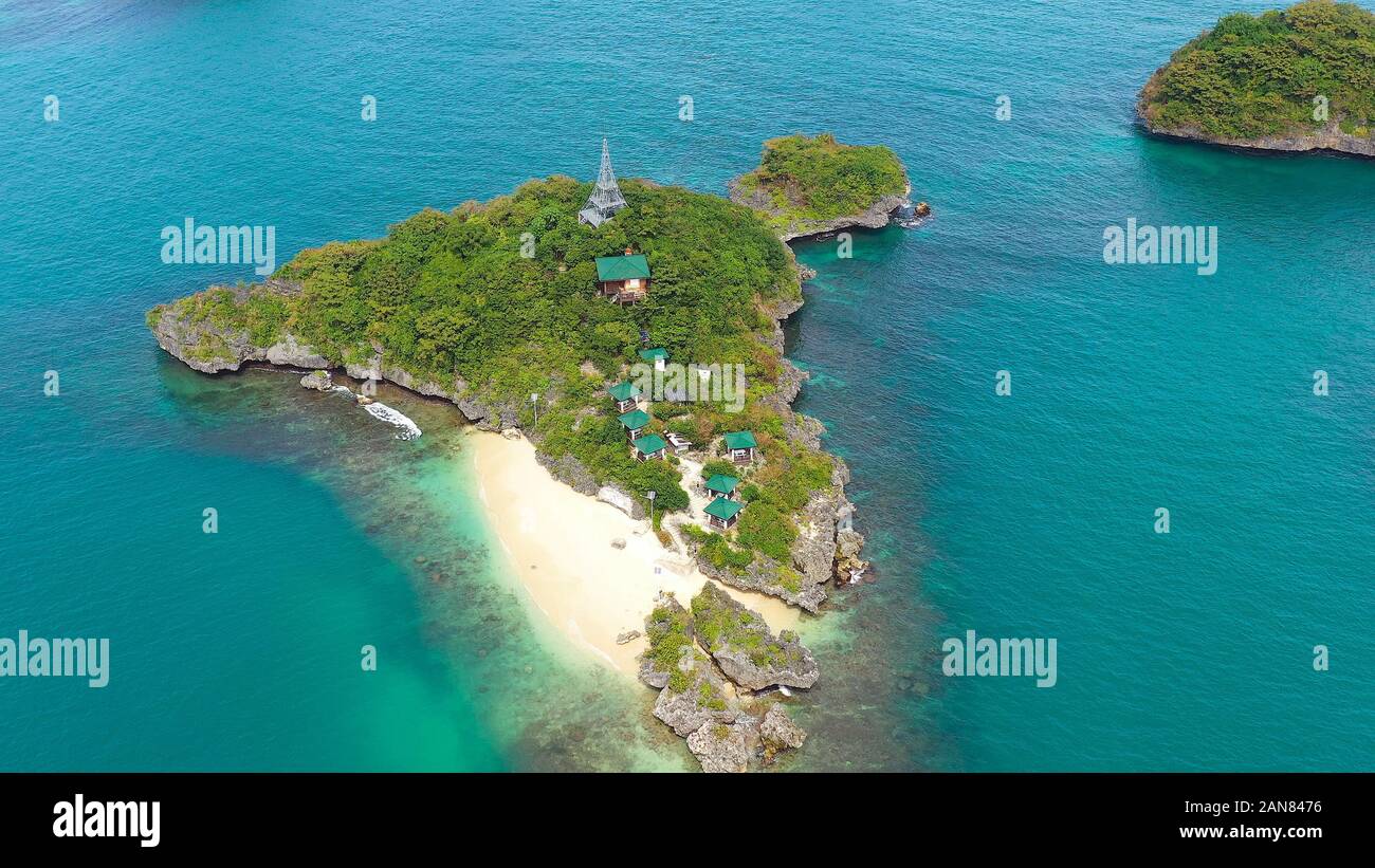 Beautiful beach on a tropical island with tourists, aerial view. Lopez ...