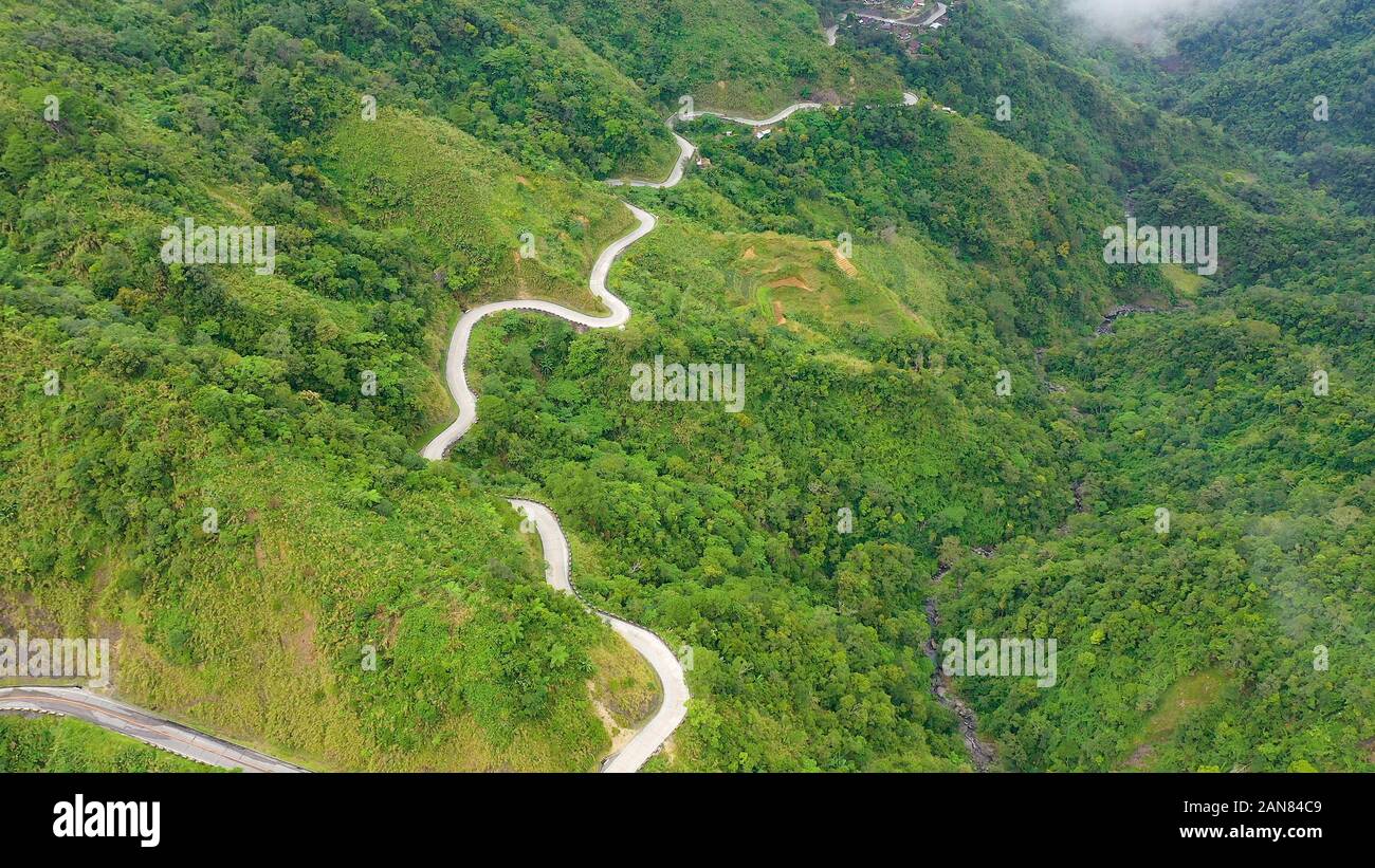 Fragment of a high altitude road in the mountains. Mountains covered by ...