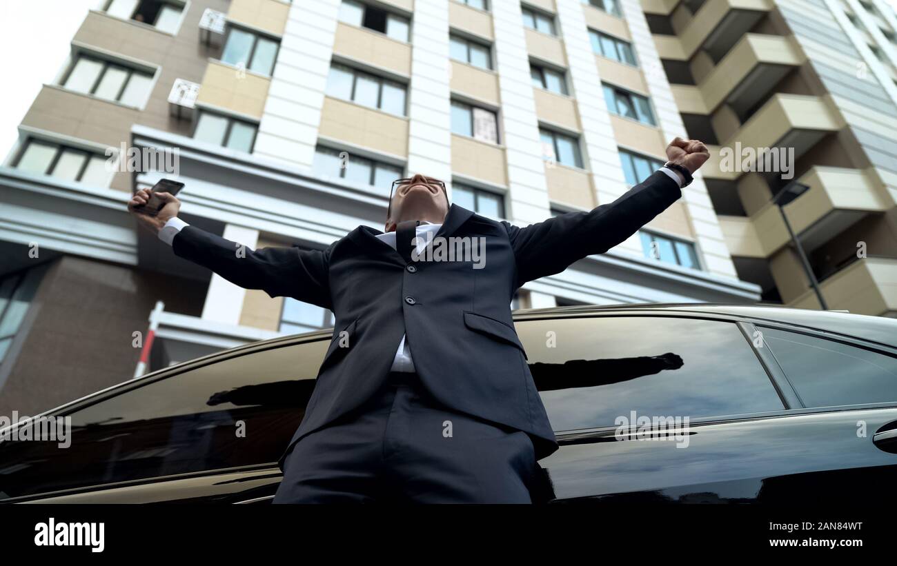 Extremely happy businessman spreading arms, lottery winner of flat and ...