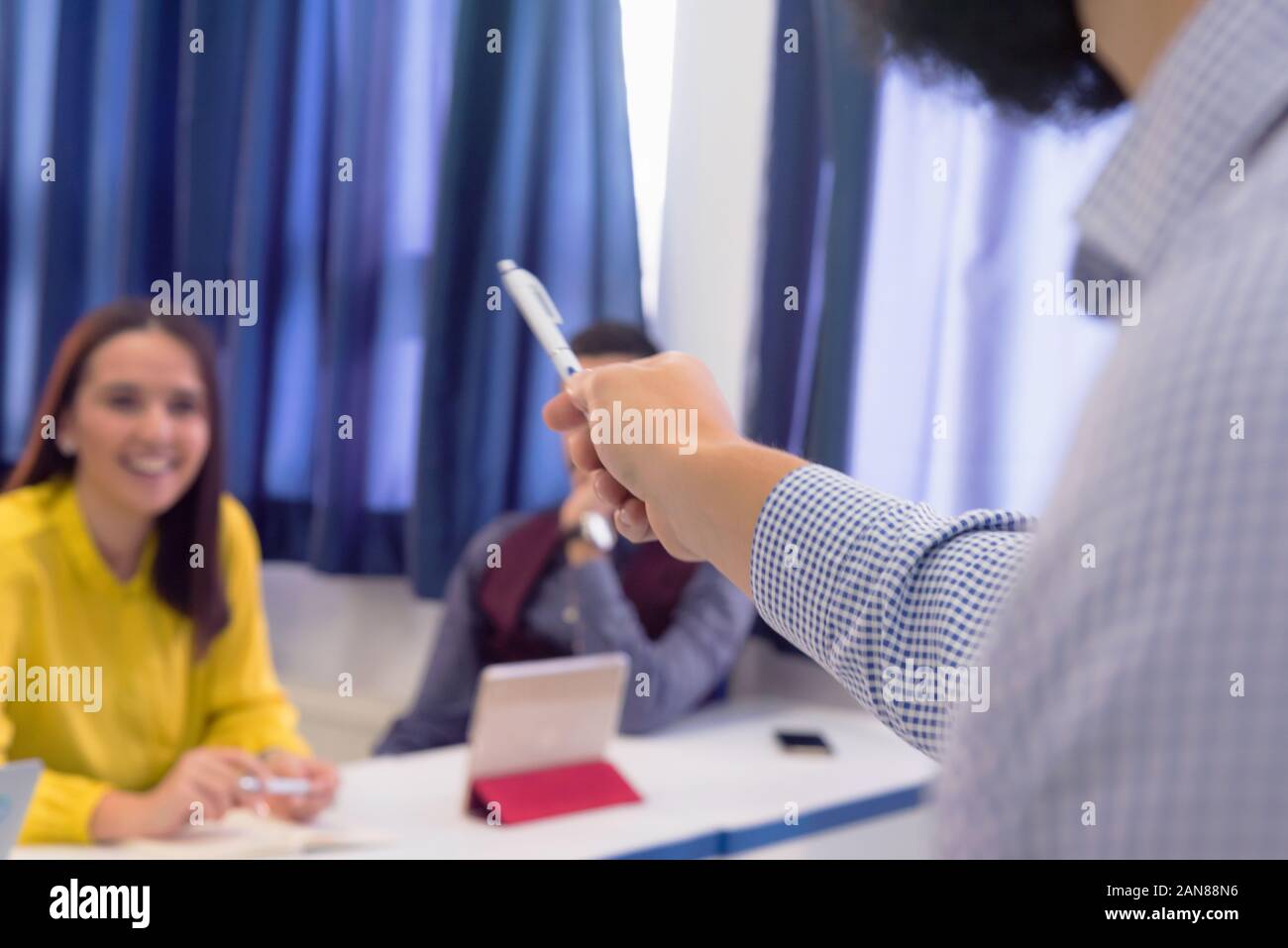 Cropped image of senior university professor pointing on something with ...