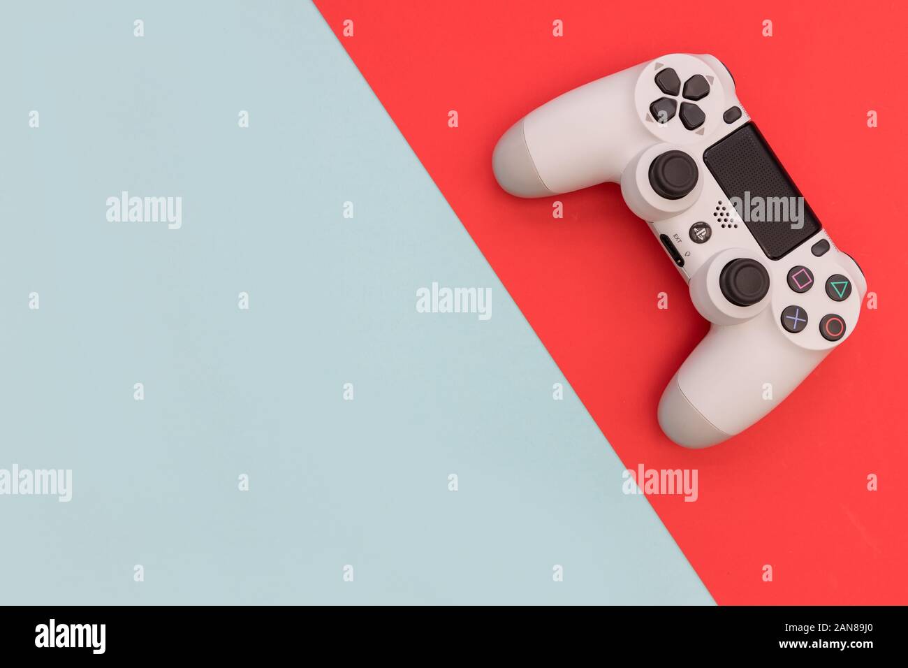 LONDON - DECEMBER 10, 2019: Video game gaming controller on bright red ...