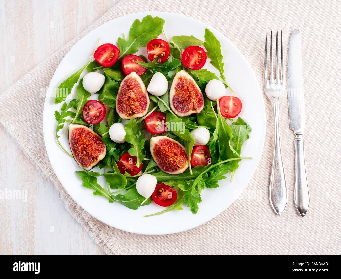 Fresh salad with figs, tomatoes, cucumbers, arugula, mozzarella. Oil ...