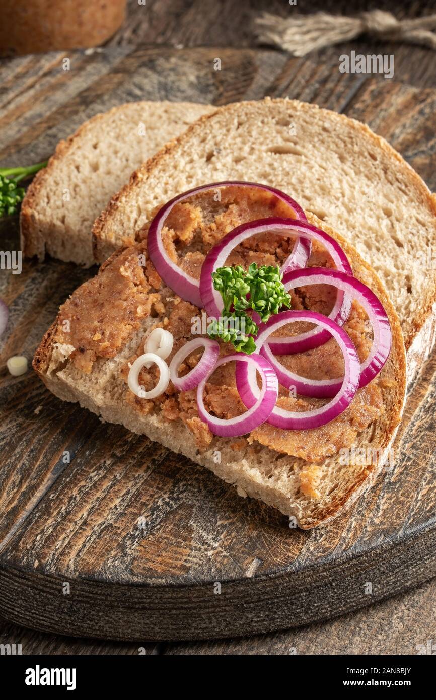 Slices of bread slathered with pork lard mixed with ground cracklings ...