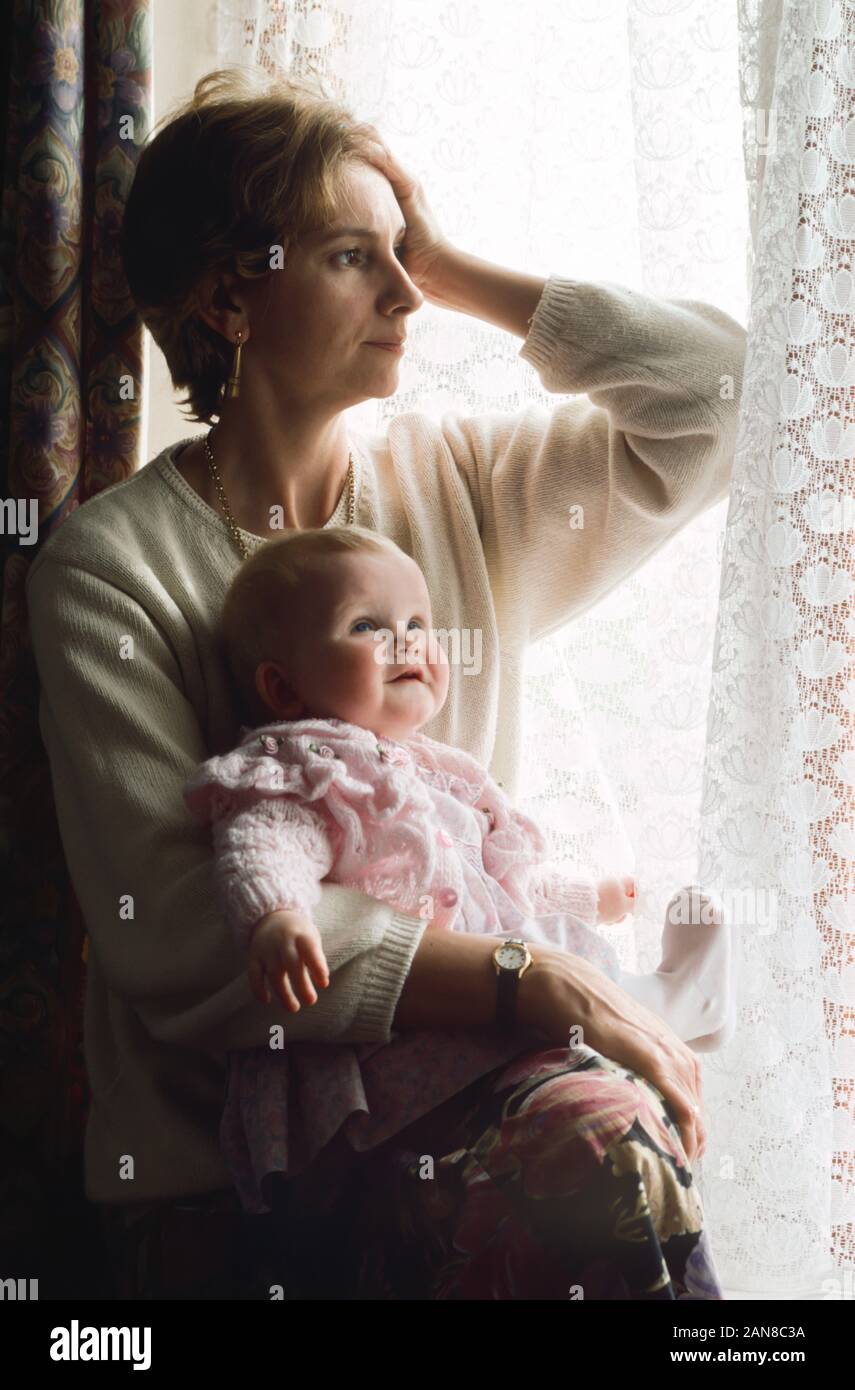 Exhausted woman looking out of window hi-res stock photography and ...