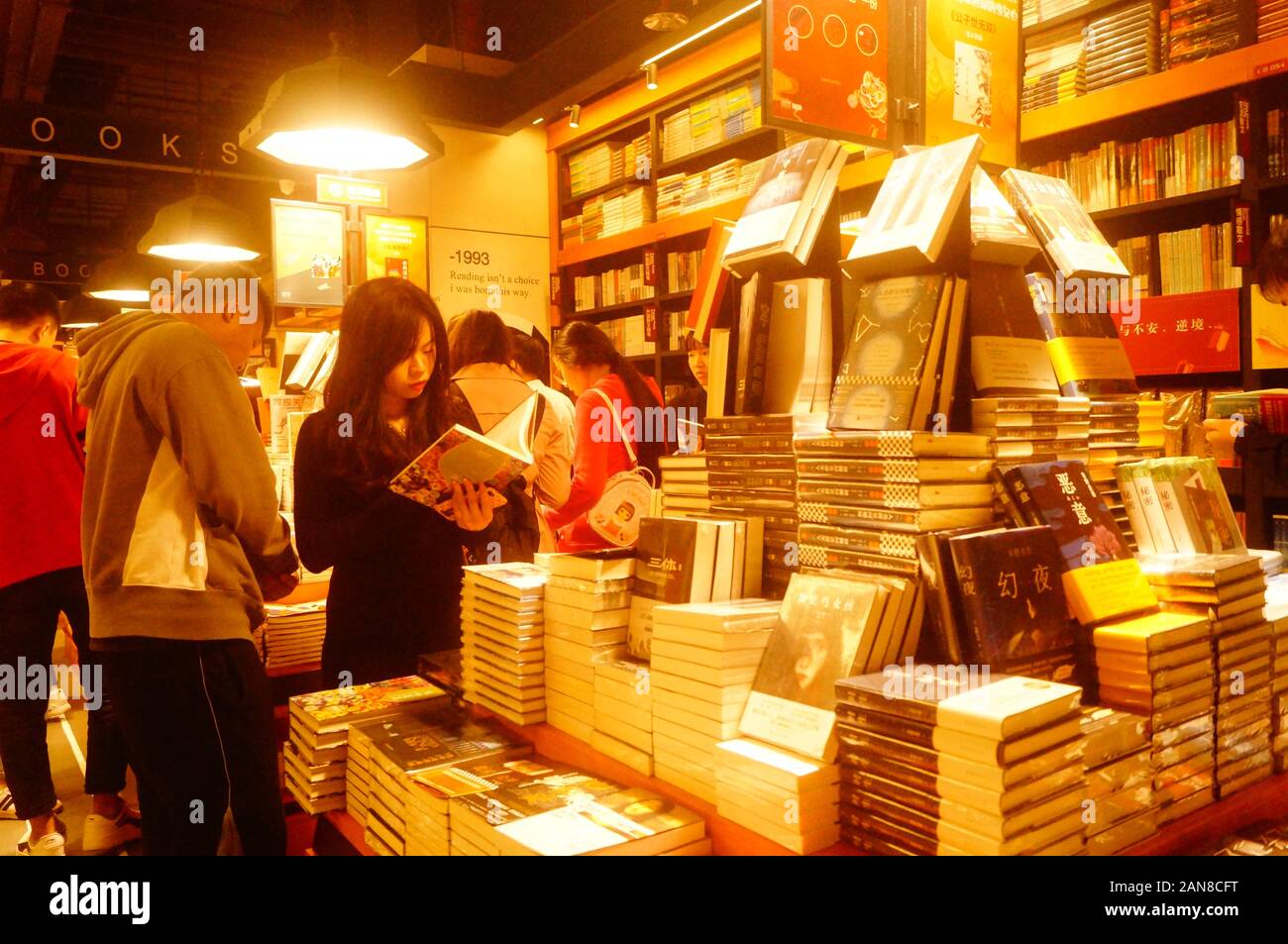 Shenzhen, China: people shop for books or read at a bookstore in a ...