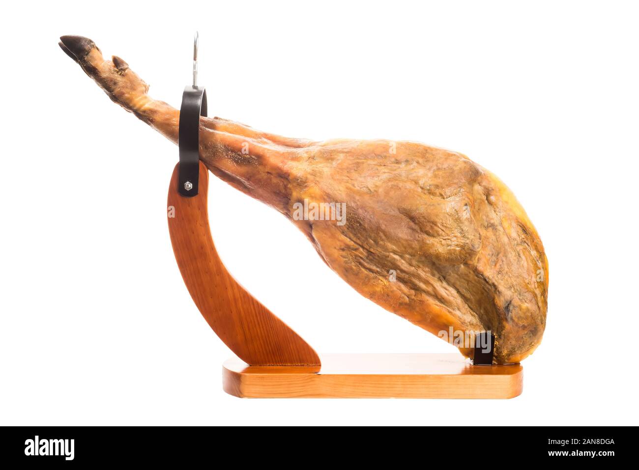 Whole Iberian ham leg in a wooden ham stand isolated on white ...