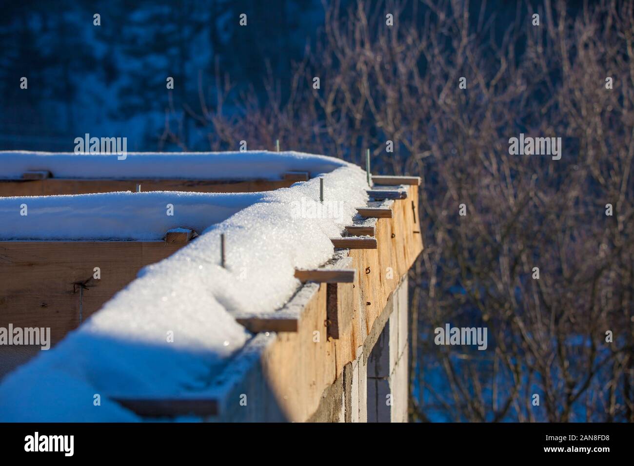 details of new building or house construction covered in winter snow ...