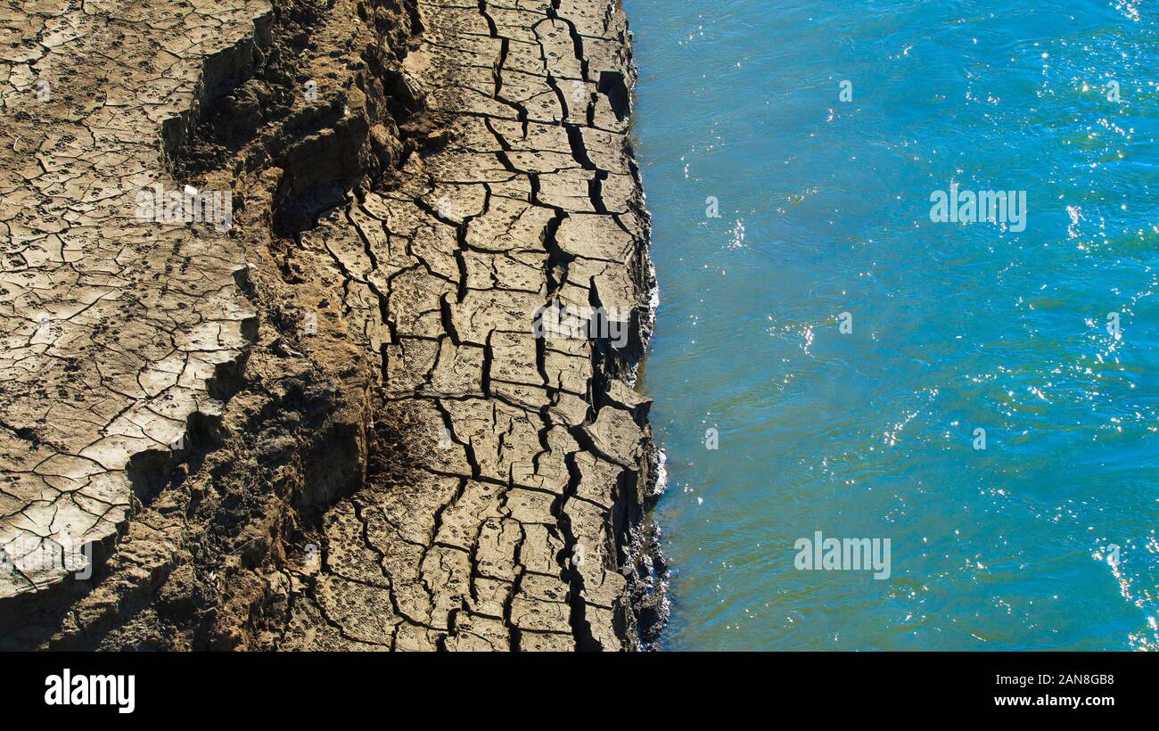 half cracked ground and soil with river, water split image Stock Photo ...