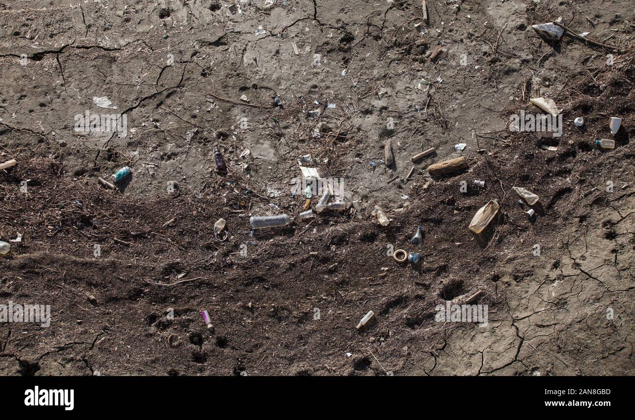 garbage an waste in the cracked soil and ground. environment pollution ...