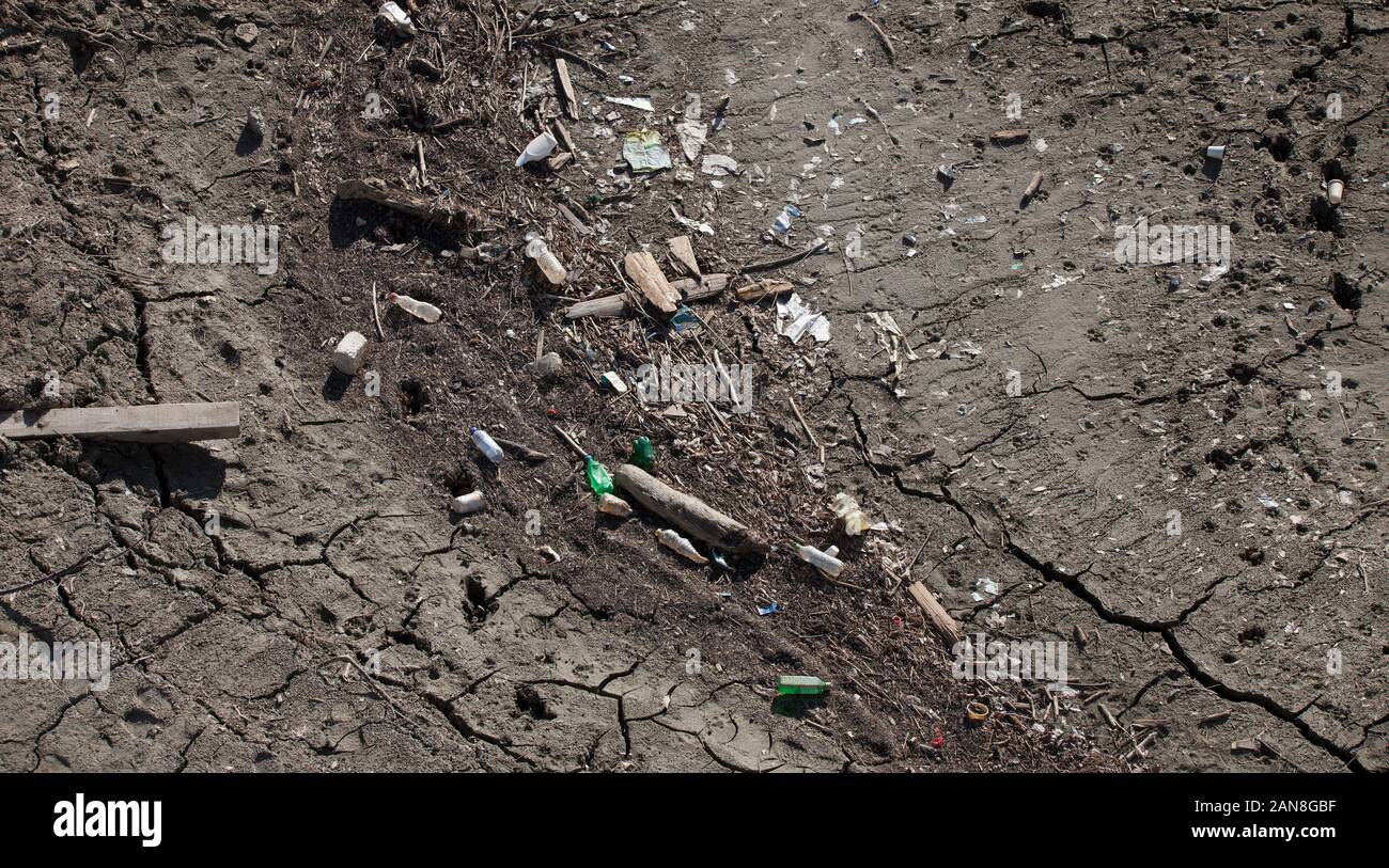 garbage an waste in the cracked soil and ground. environment pollution ...
