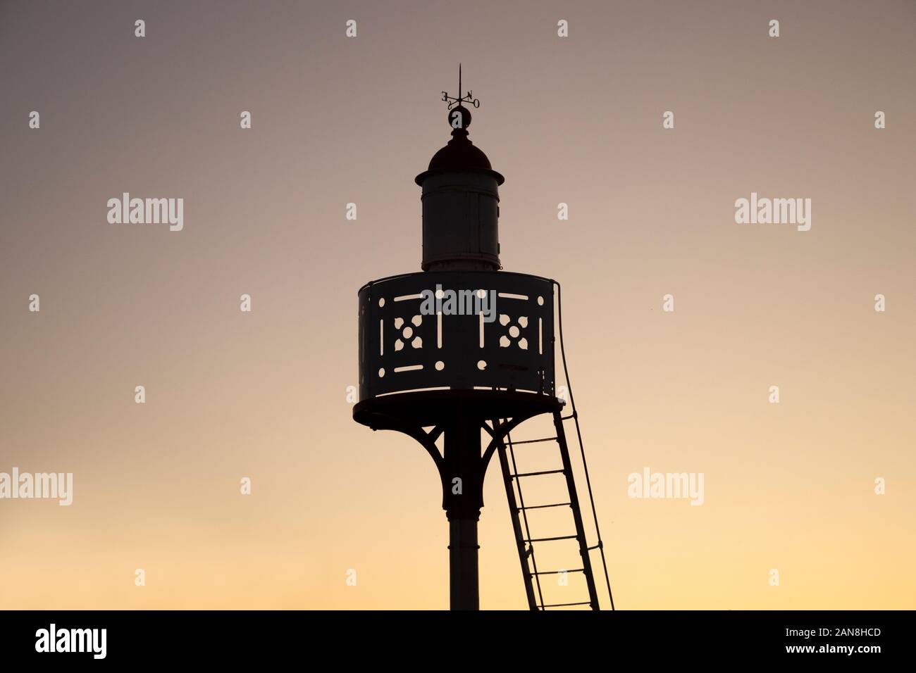 Silhouette of a Lighthouse Tower at Sunset with a Ladder Leading Up ...