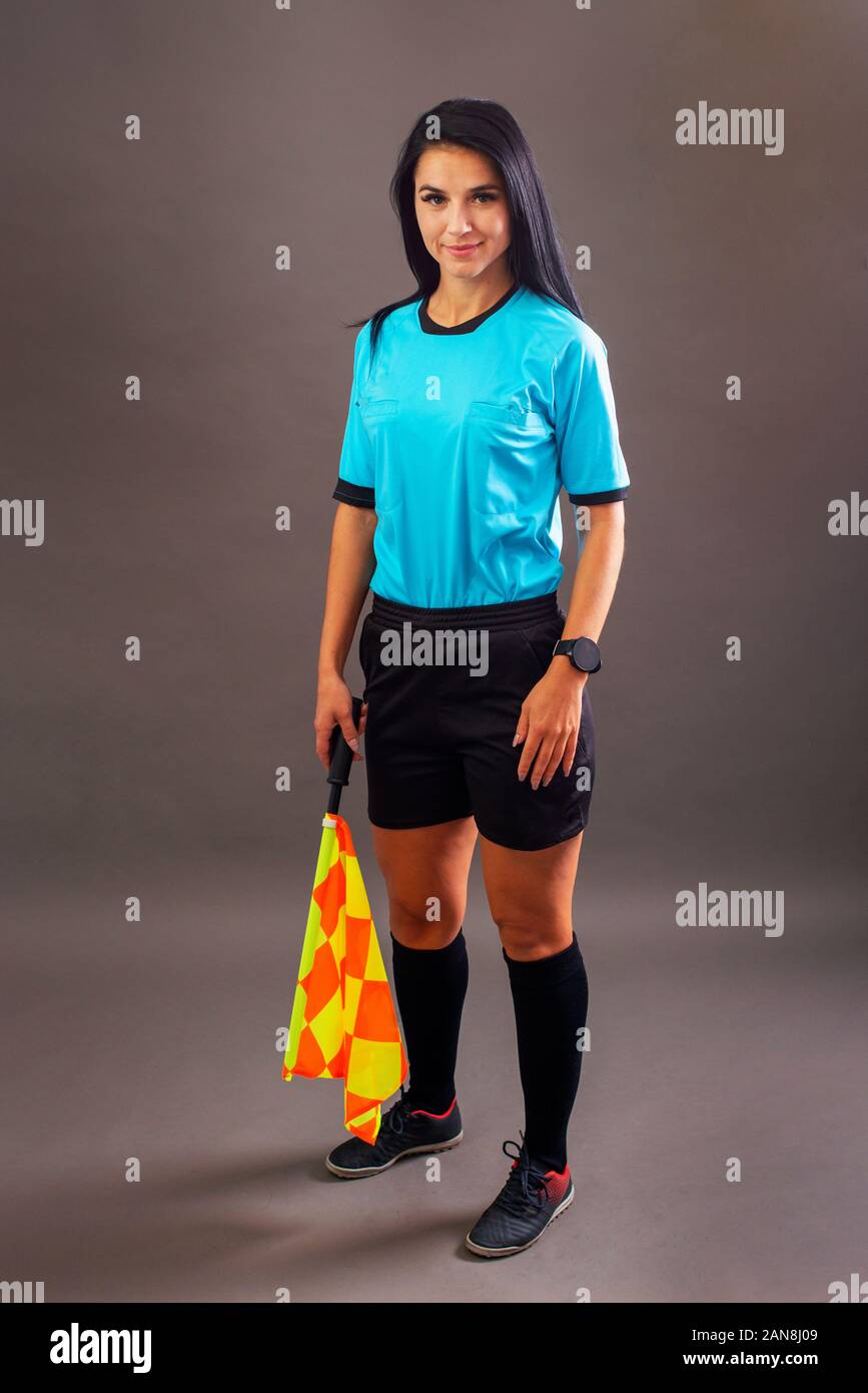 Beautiful Soccer Referee with flag in hand looking at camera and smile ...