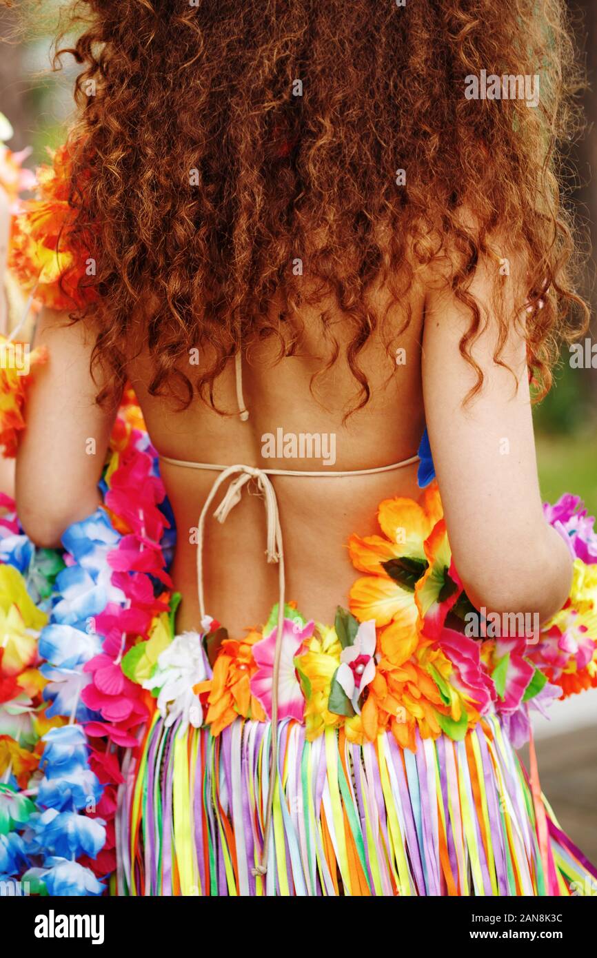Back view of woman in hawaiian costume with curl red hair, aloha girl with flowers Stock Photo ...