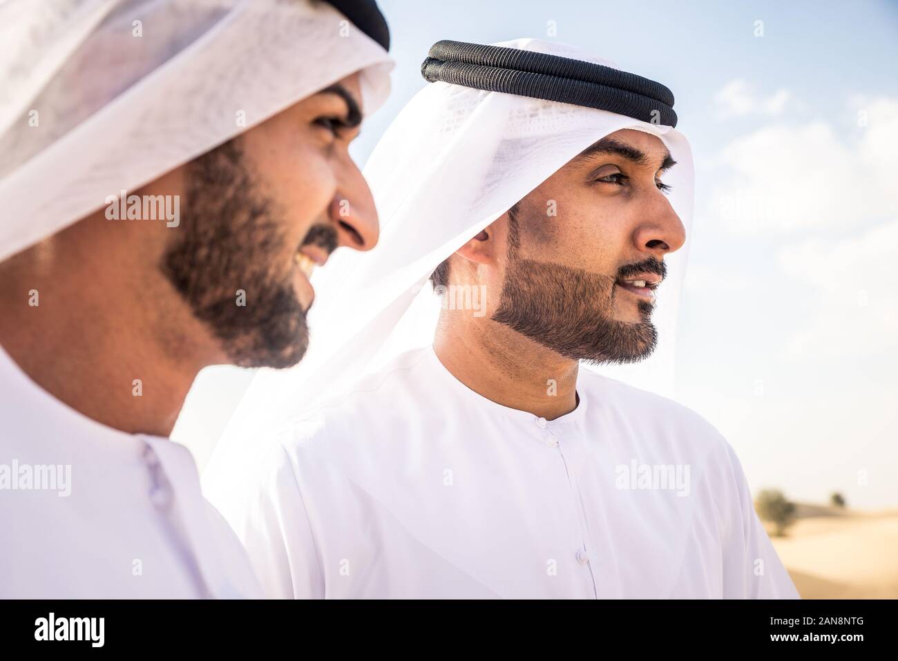 Two business men wearing traditional uae white kandura spending time in ...