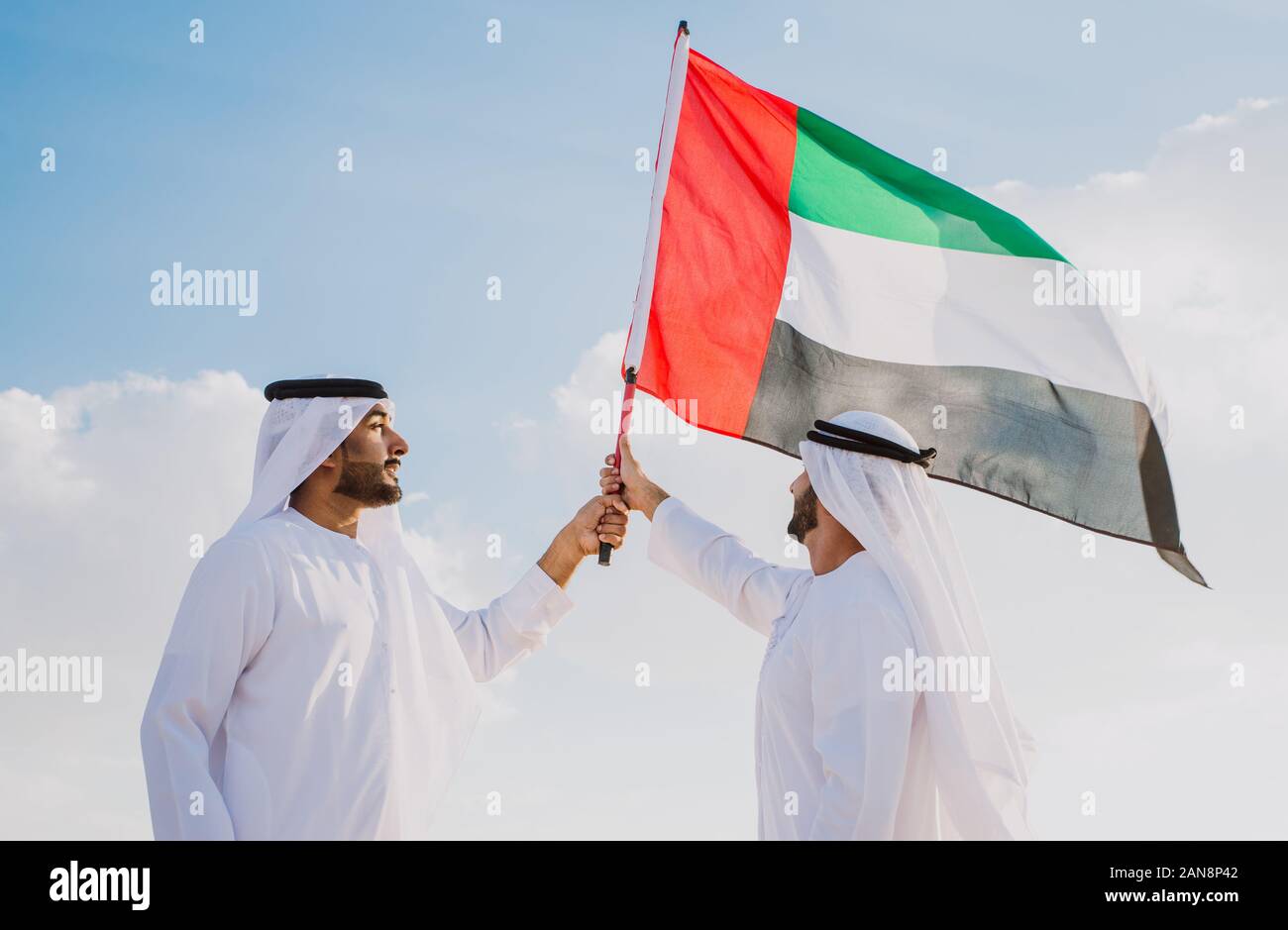 Two business men wearing traditional uae white kandura spending time in ...