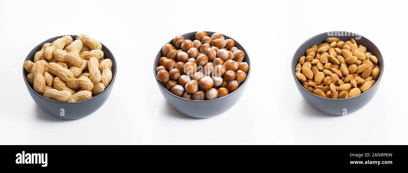 Peanuts, hazelnuts and almonds nuts in bowl, isolated white background ...