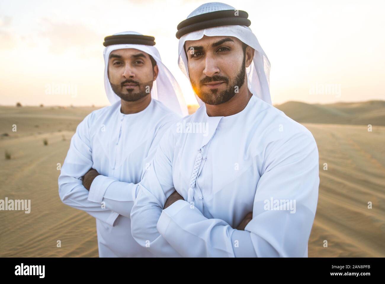Two business men wearing traditional uae white kandura spending time in ...