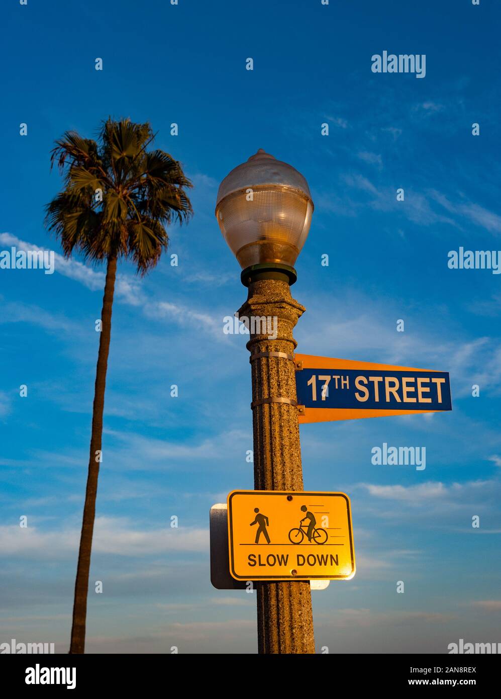 Newport beach street sign and lamp lit up by sunset light, 17th street ...