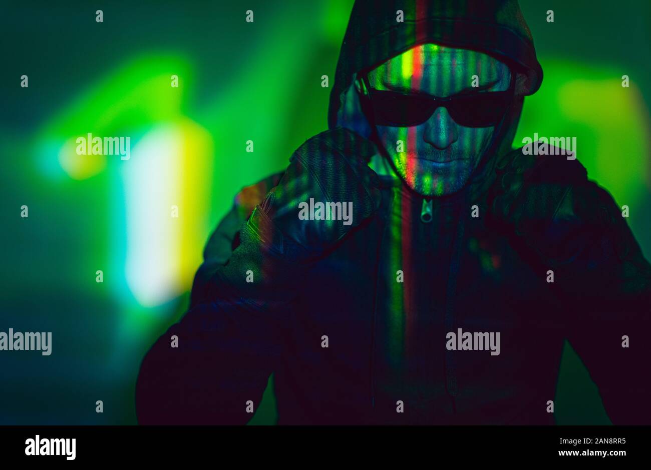 Caucasian Hacker Wearing Hood and Sunglasses Hiding His Face. Greenish ...