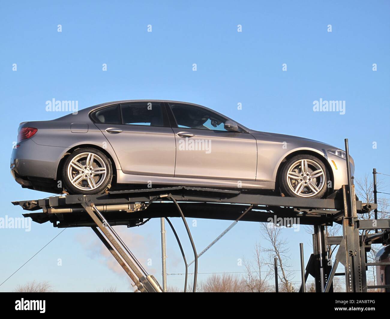 Car is raised high up on a platform and flat bed Stock Photo - Alamy