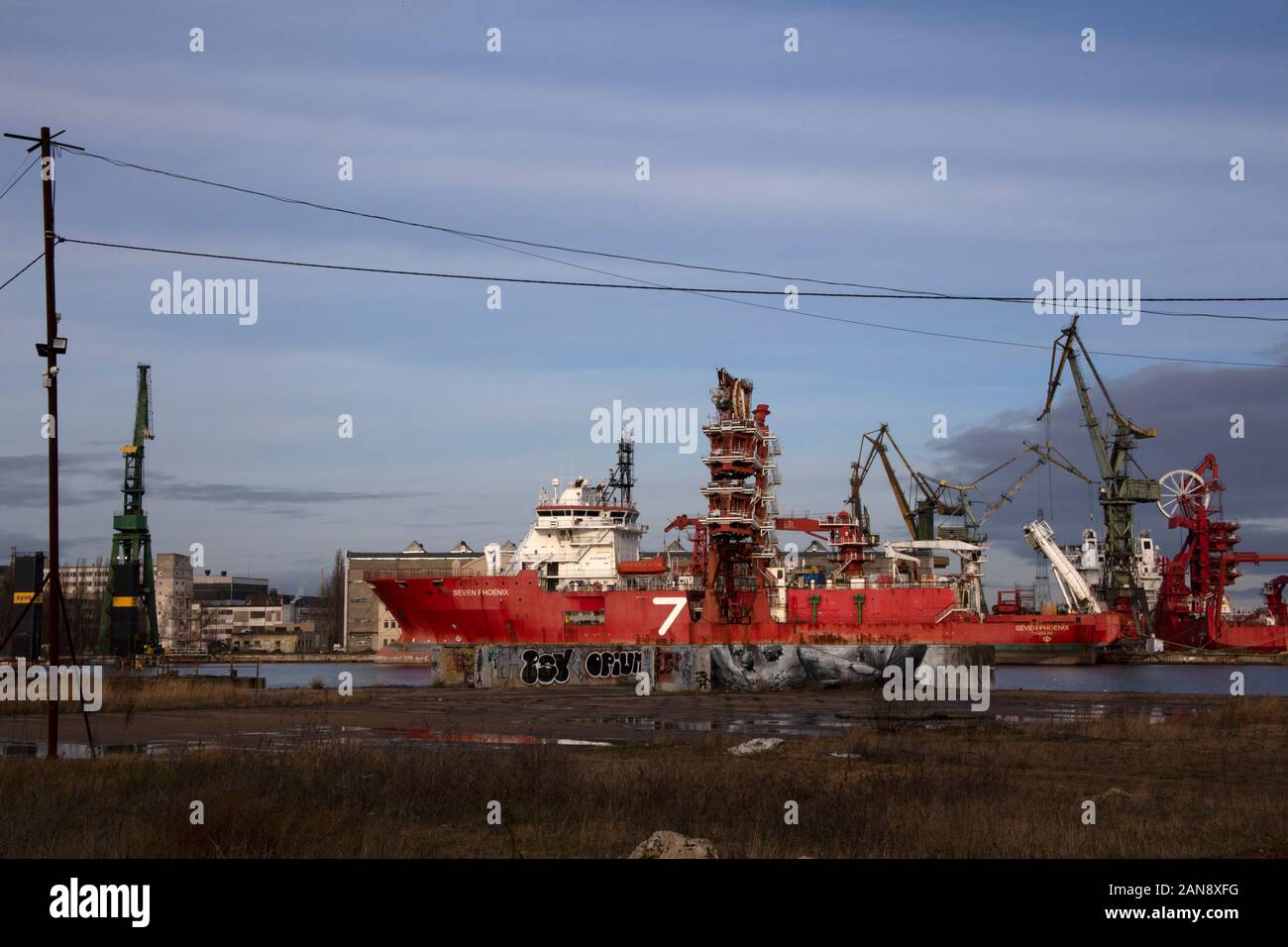 Red ship and harbour cranes in Gdansk shipyard - Stocznia Gdańska ...