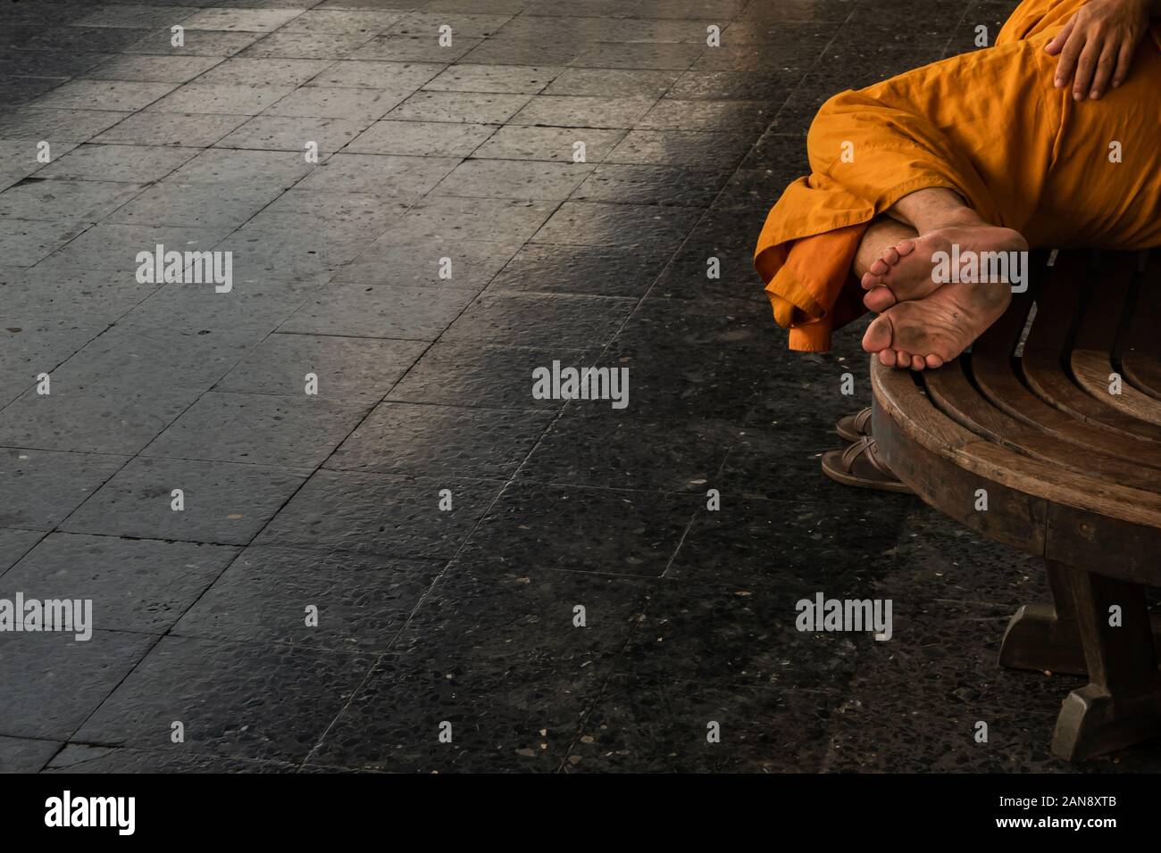 Bangkok, thailand - Jul 7, 2019 : A monk is sleep on wooden chairs are ...