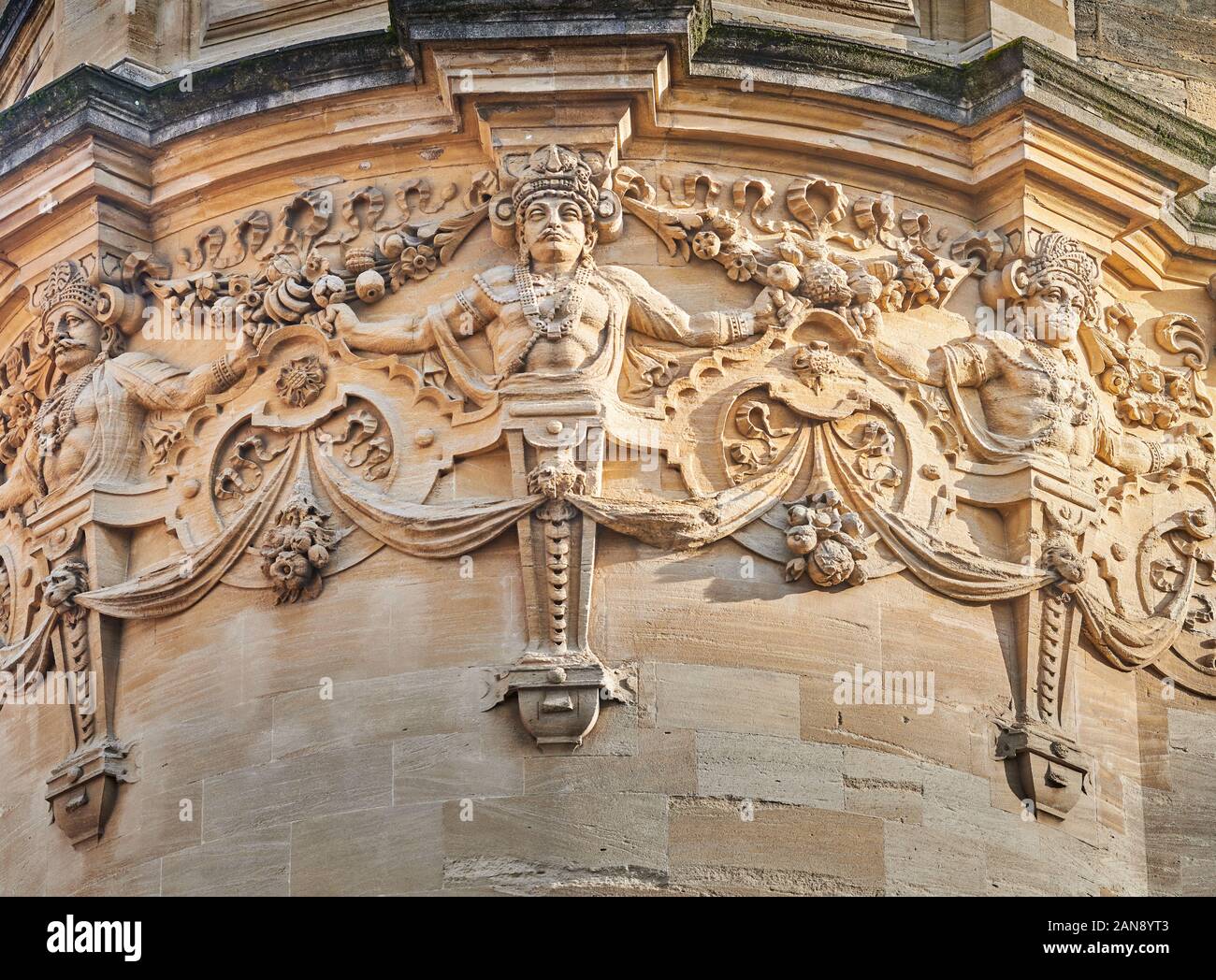 Hindu style stone sculptures on the stone wall of the cupola at the ...