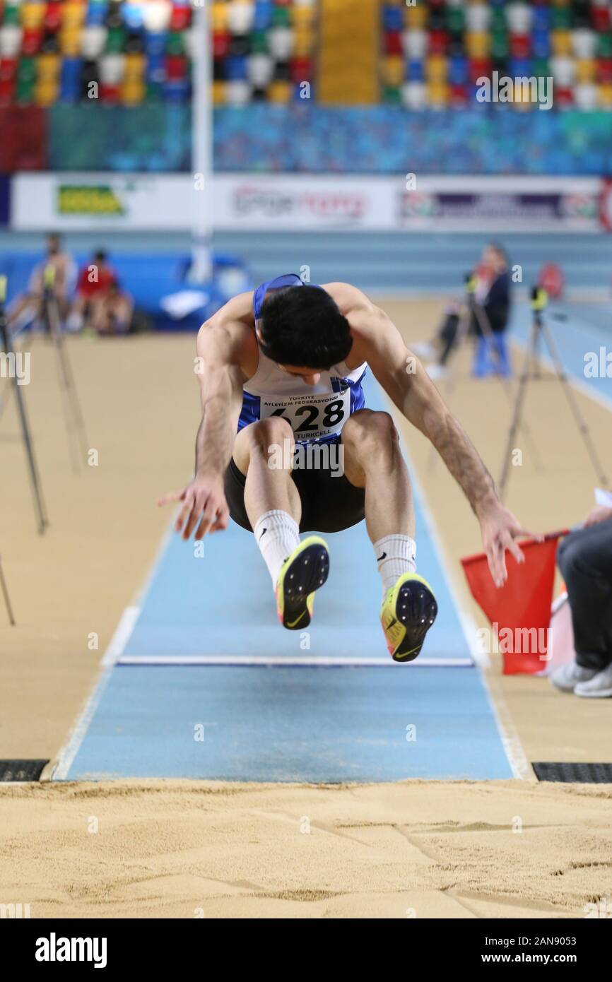 ISTANBUL, TURKEY - JANUARY 11, 2020: Undefined athlete long jumping ...