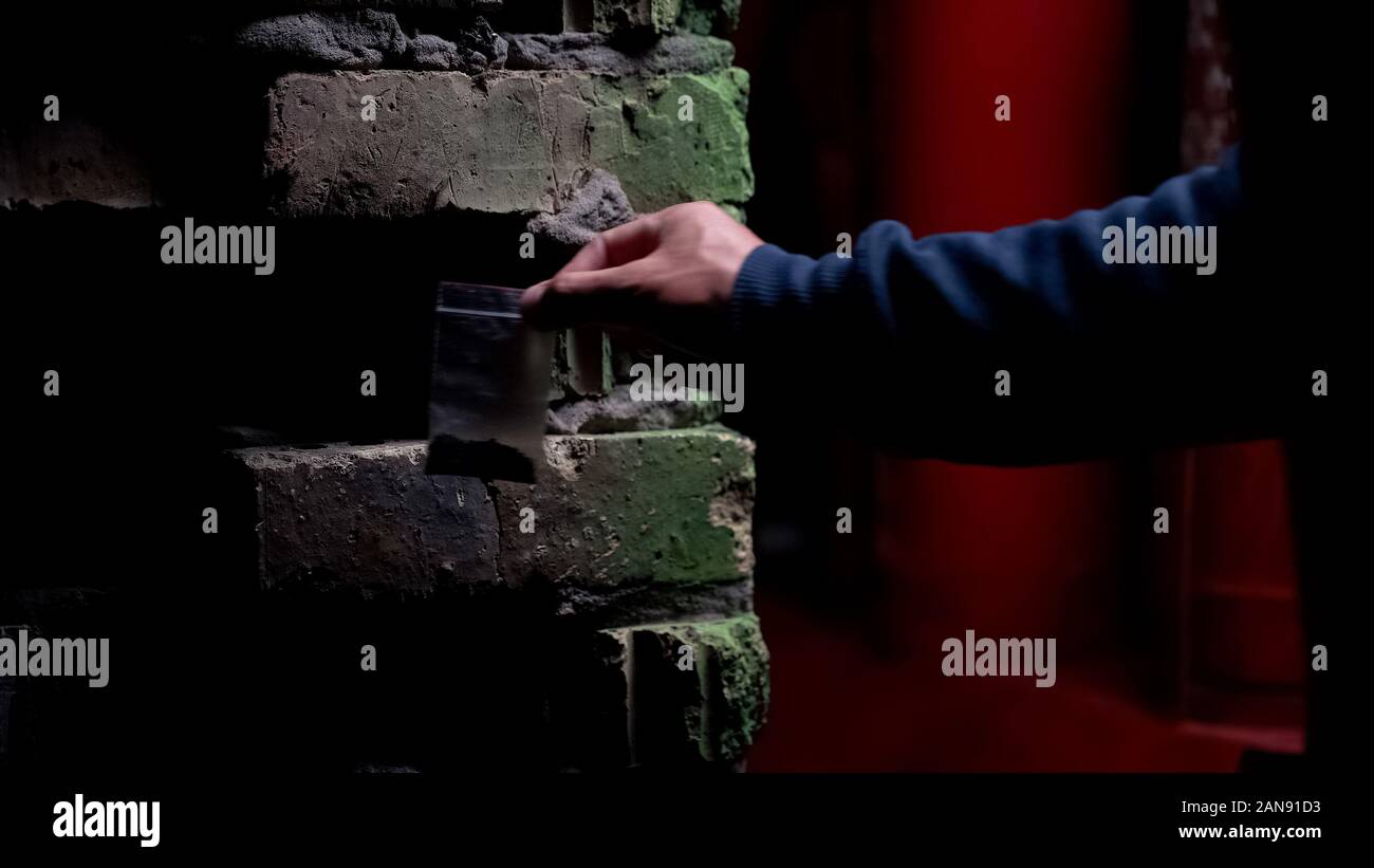 Drug dealer taking marijuana packet from secret hideout and leaving ...