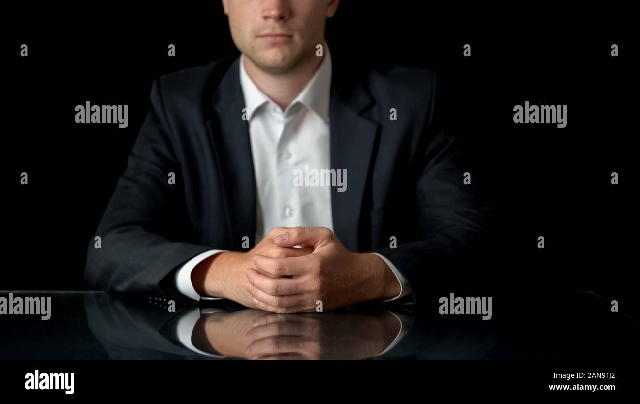 Strict business man sitting at table during job interview, black ...