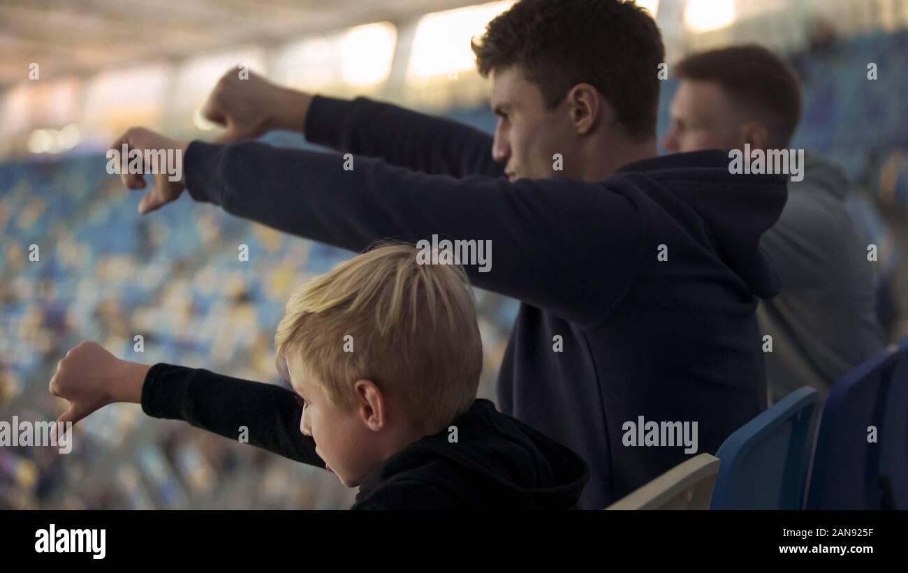 Student fans and little boy booing sport game at stadium, watching ...