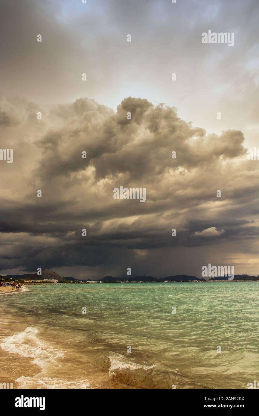 Violent storm clouds on the beach in the bay of Alcudia in Mallorca ...