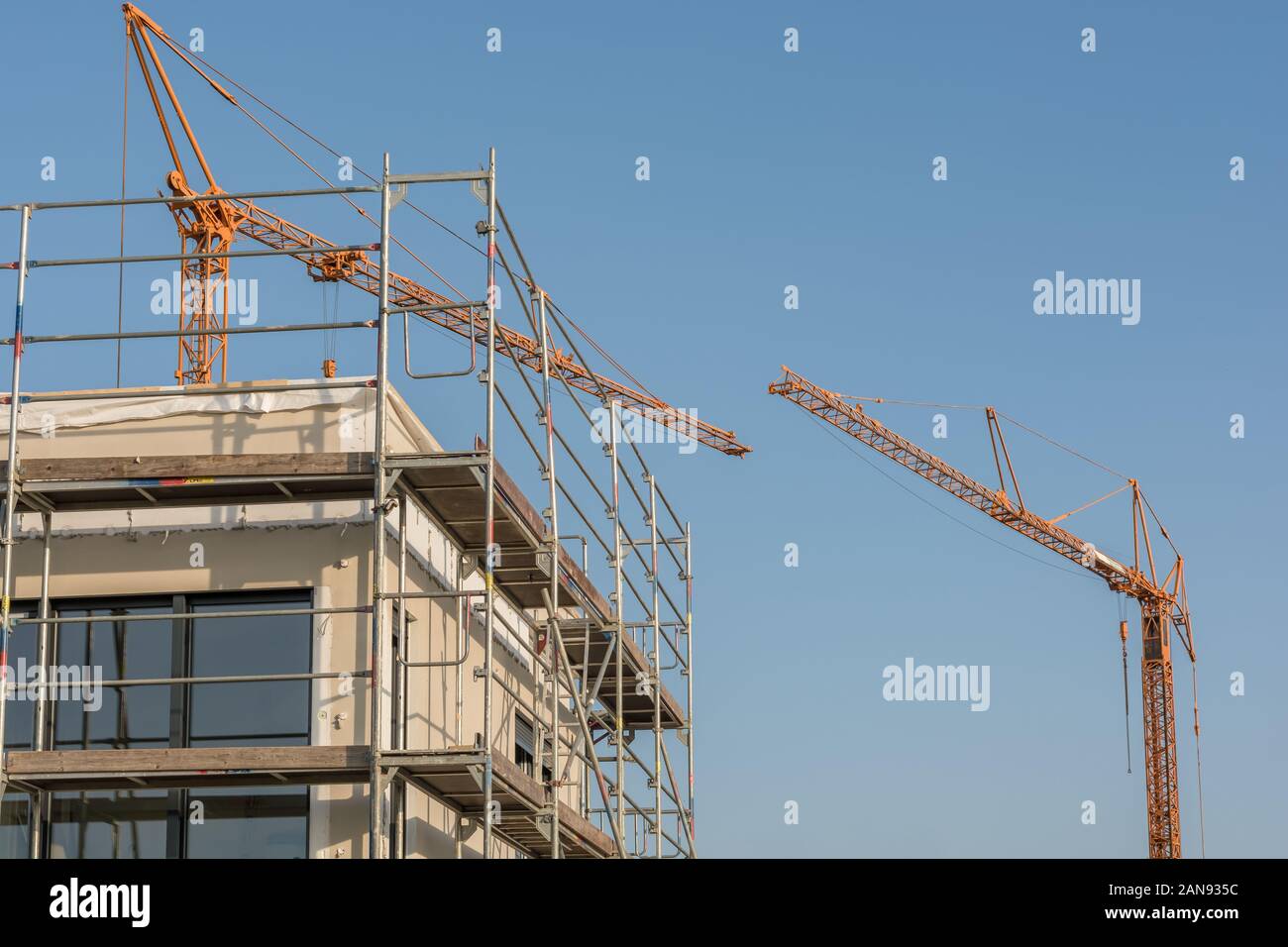 House building with two tower cranes Stock Photo - Alamy